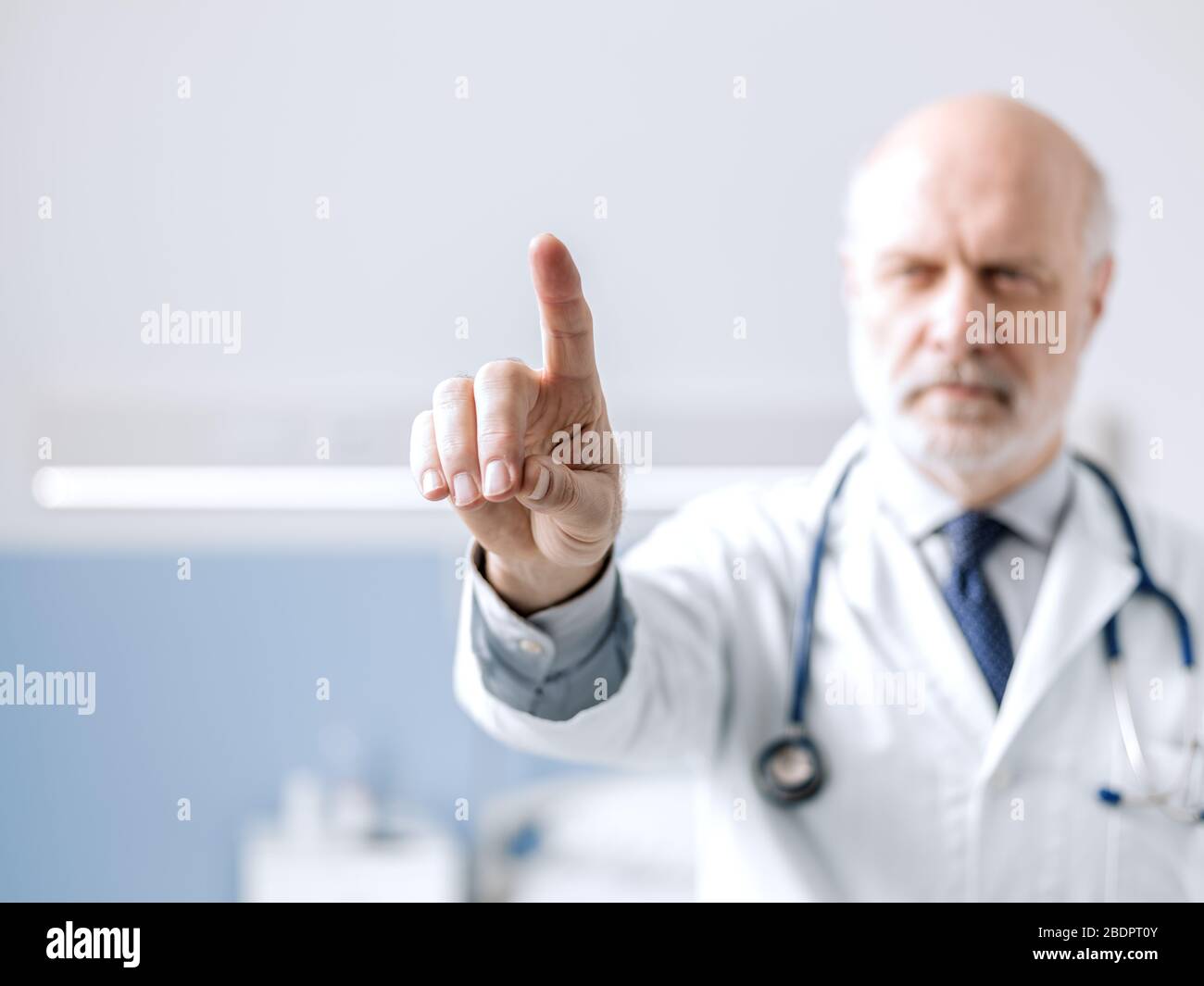 Professional doctor at the hospital, he is pointing with a finger and ...