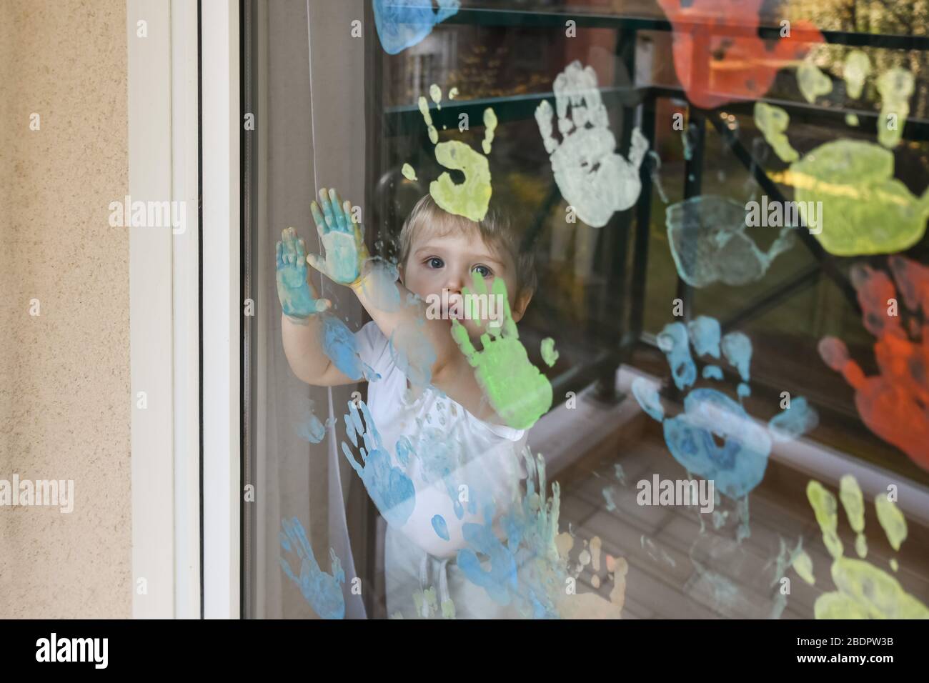 Kids paint with palms on the window. Quarantine Stock Photo - Alamy