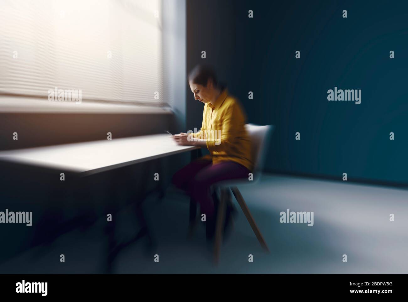 Sad lonely woman isolated at home and chatting with her smartphone ...