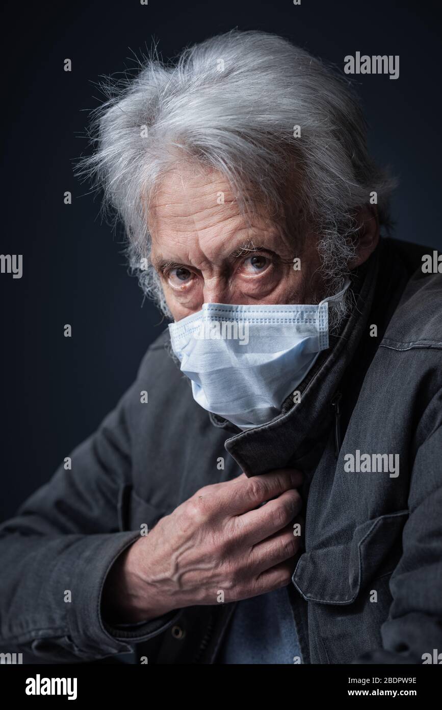 Elder man wearing a protective face mask and looking at camera, covid ...