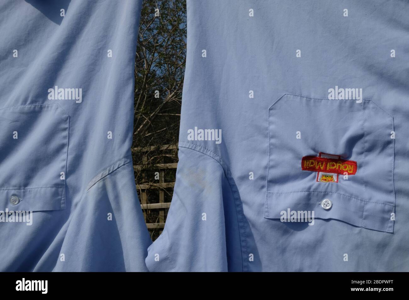 Royal Mail uniform hanging on the washing line Stock Photo - Alamy