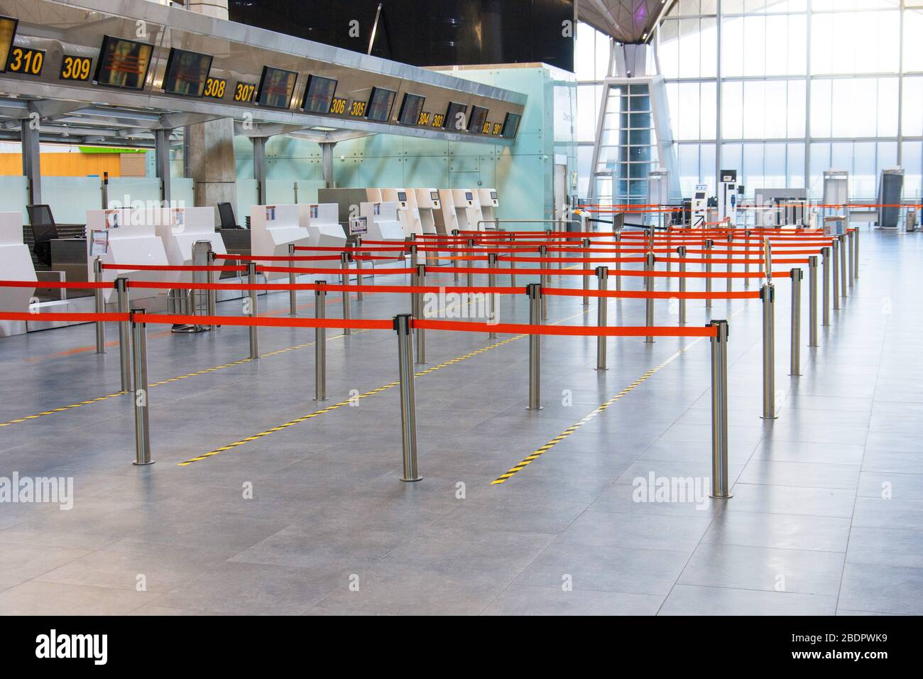 Empty passenger terminal at the airport. Paths limited and separated by ...