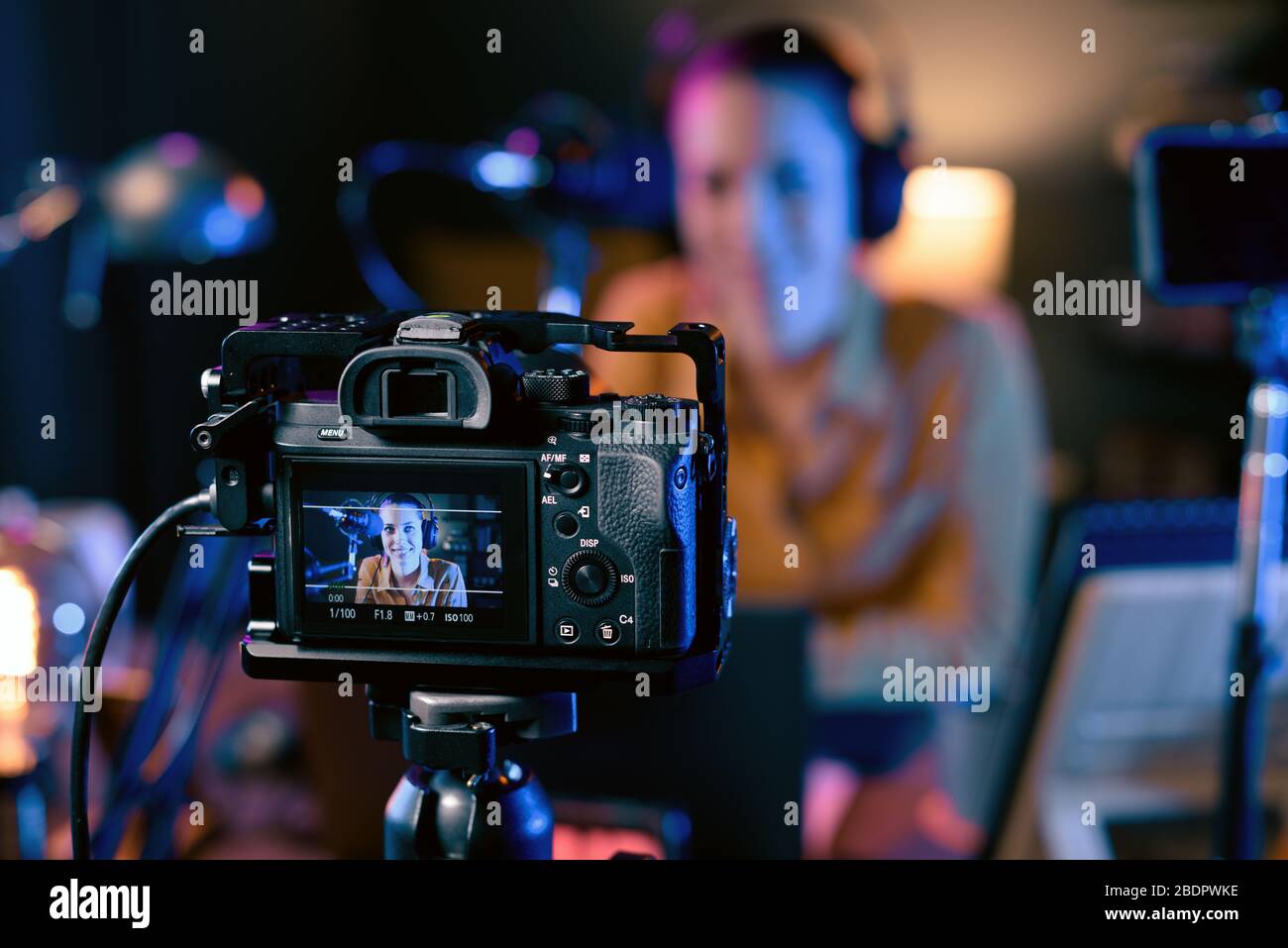 Young youtuber recording a video in her studio, professional camera in ...