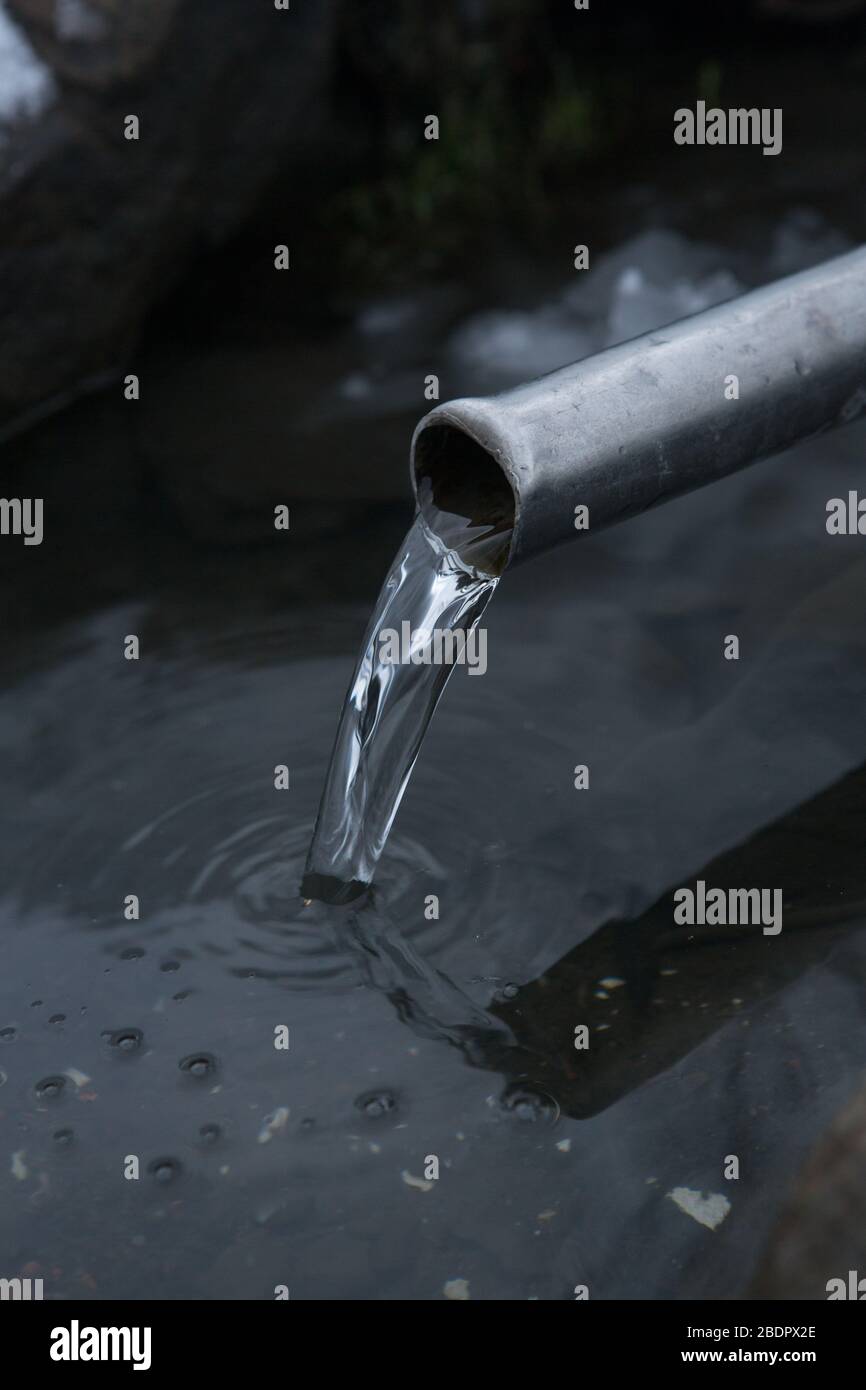 spring water, pure water runs through a small pipe Stock Photo - Alamy