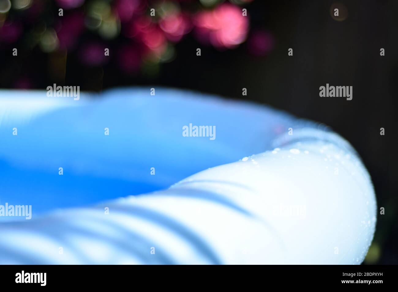 Waterdrops on inflatable swimming pool in garden on a summer day Stock ...
