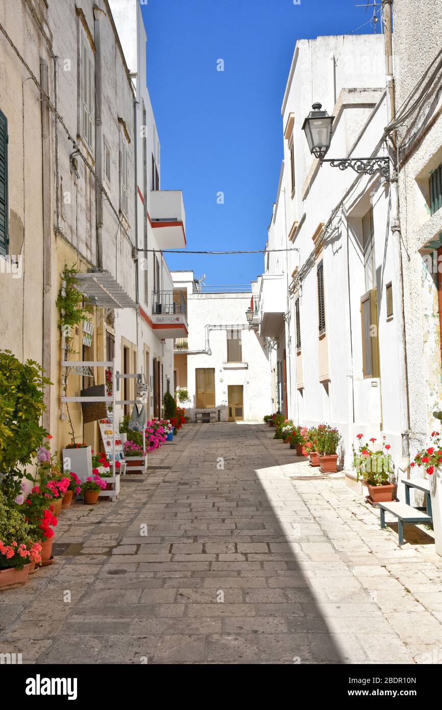 A narrow street between the houses of Castro, a town in the Puglia ...