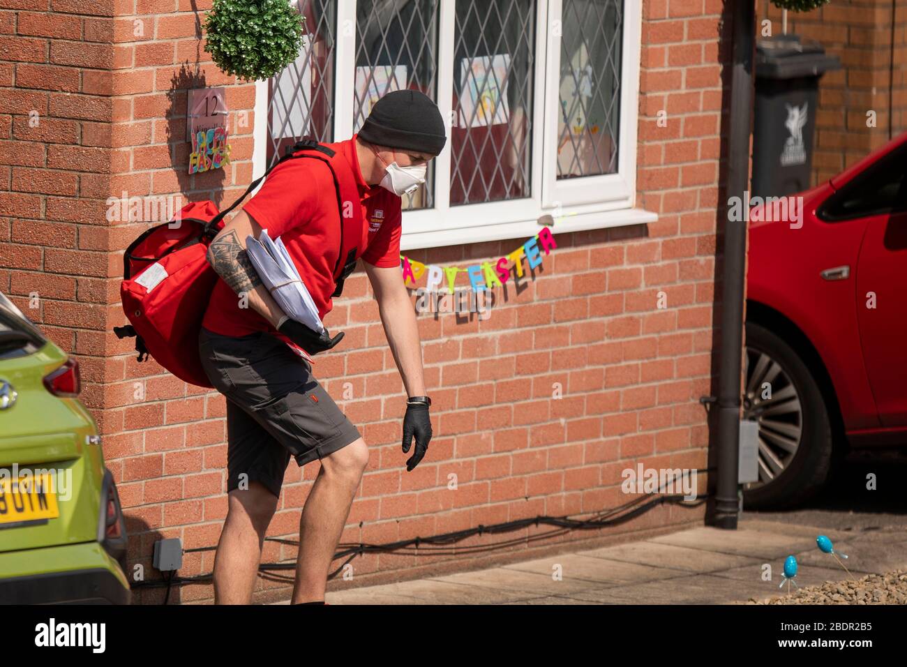 A Royal Mail postman on his rounds during the coronavirus lockdown ...
