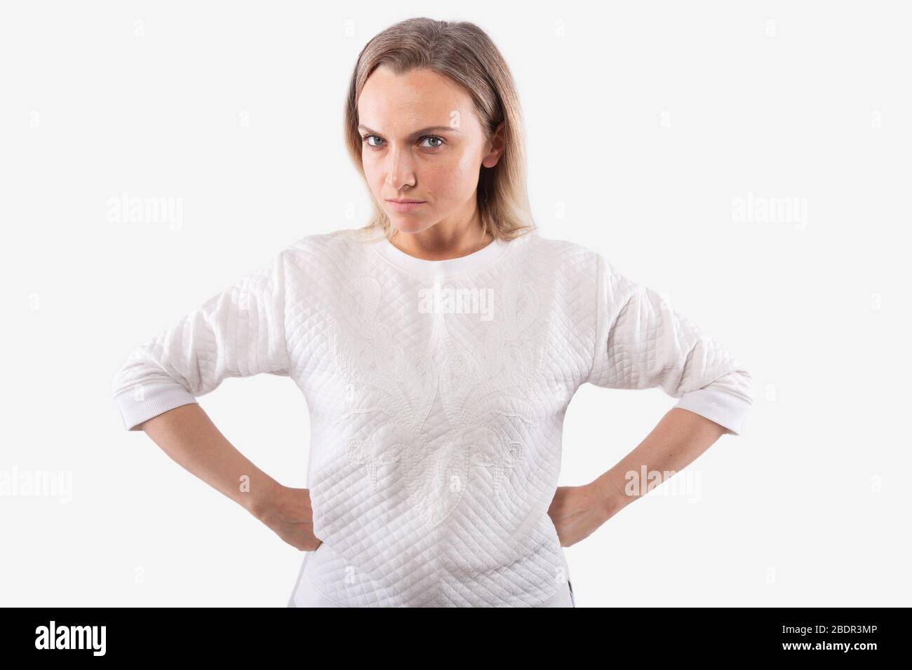 Serious woman angry looks from under the forehead. Hands on waist ...