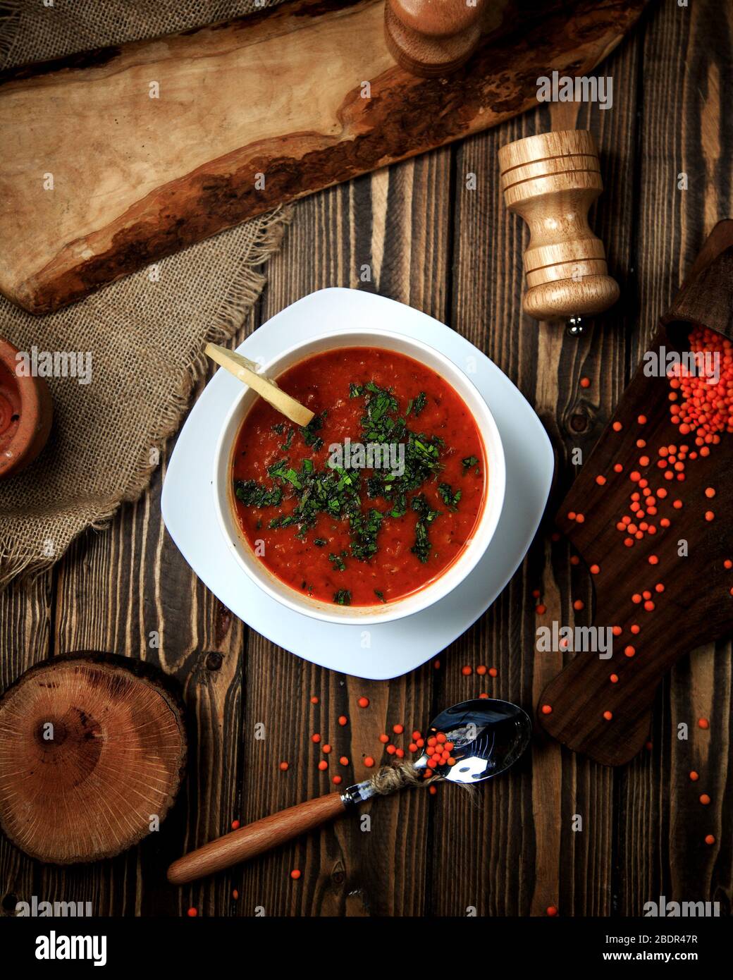 red soup with lots of herbs on top Stock Photo - Alamy