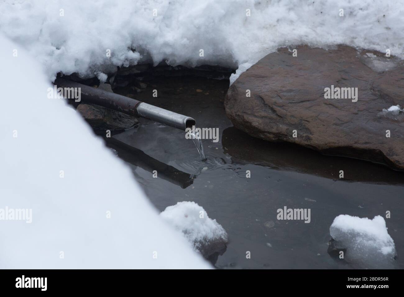 spring water, pure water runs through a small pipe Stock Photo - Alamy