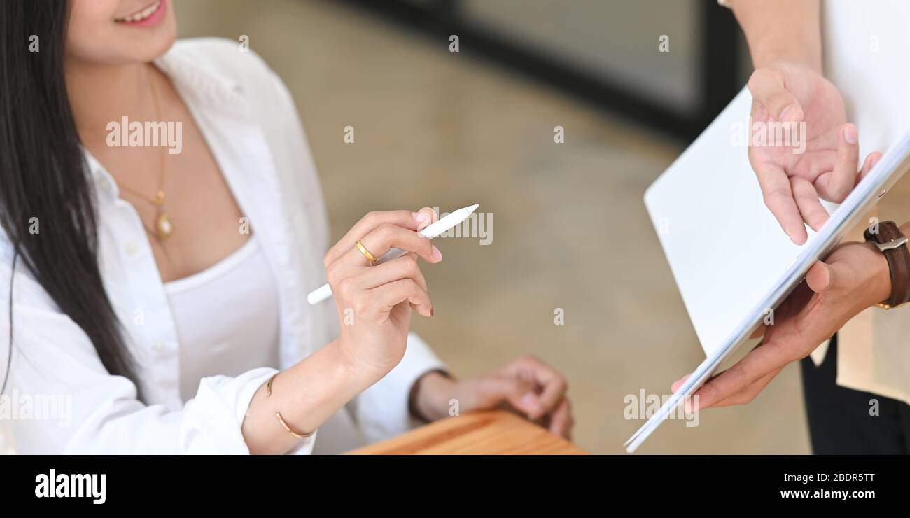 Close-up woman working as secretary working/talking with her boss while ...