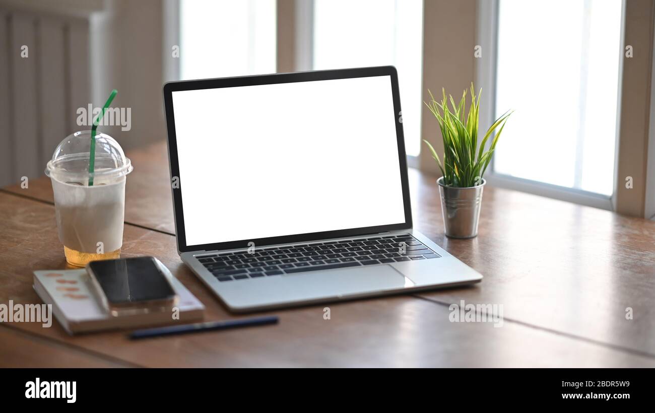 Photo of computer laptop with white blank screen putting on wooden ...