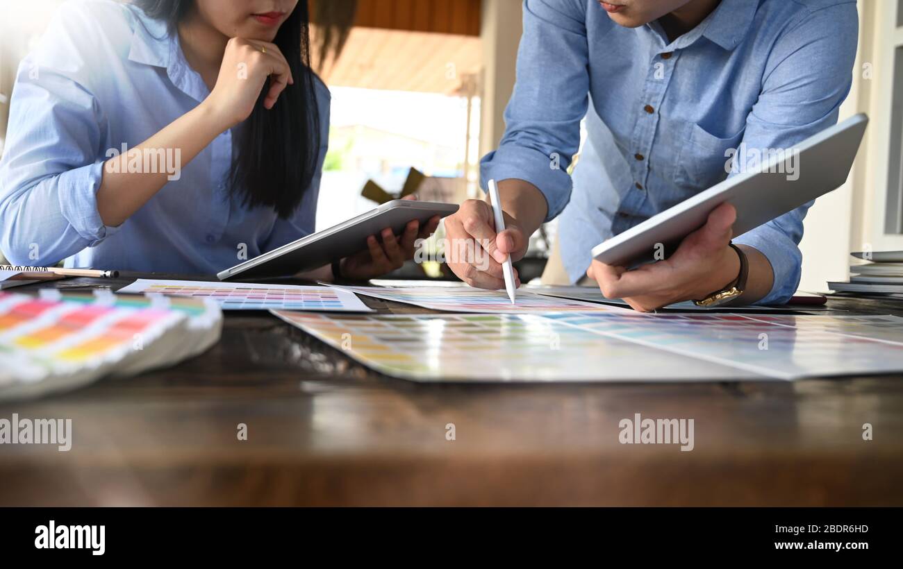 Photo of graphic designer team working together with computer tablet ...