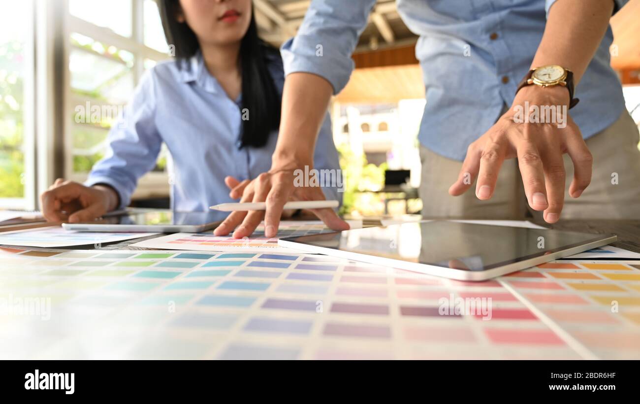 Photo of graphic designer team working together with computer tablet ...