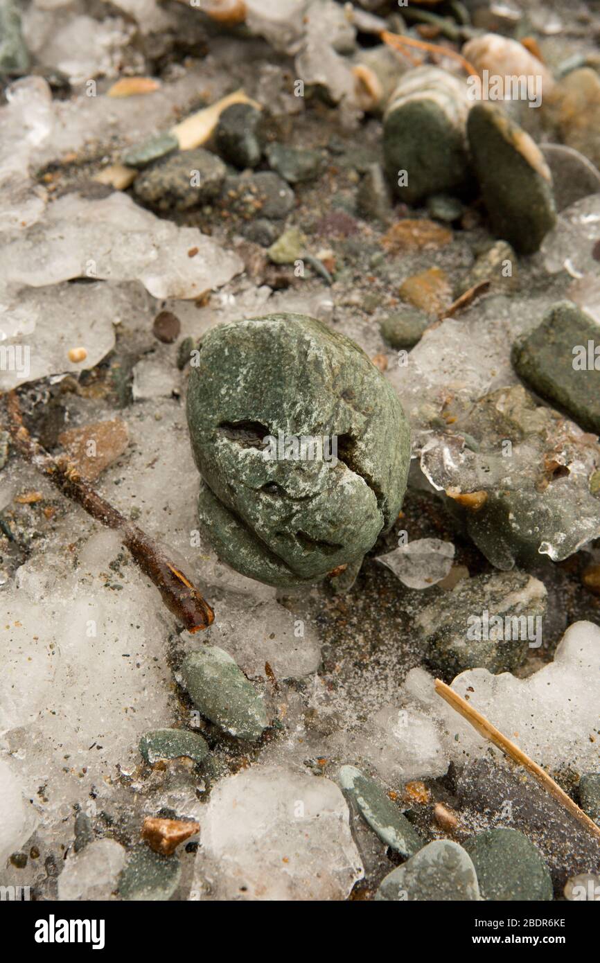 On the shore, one stone stands apart from the others. A small stone ...