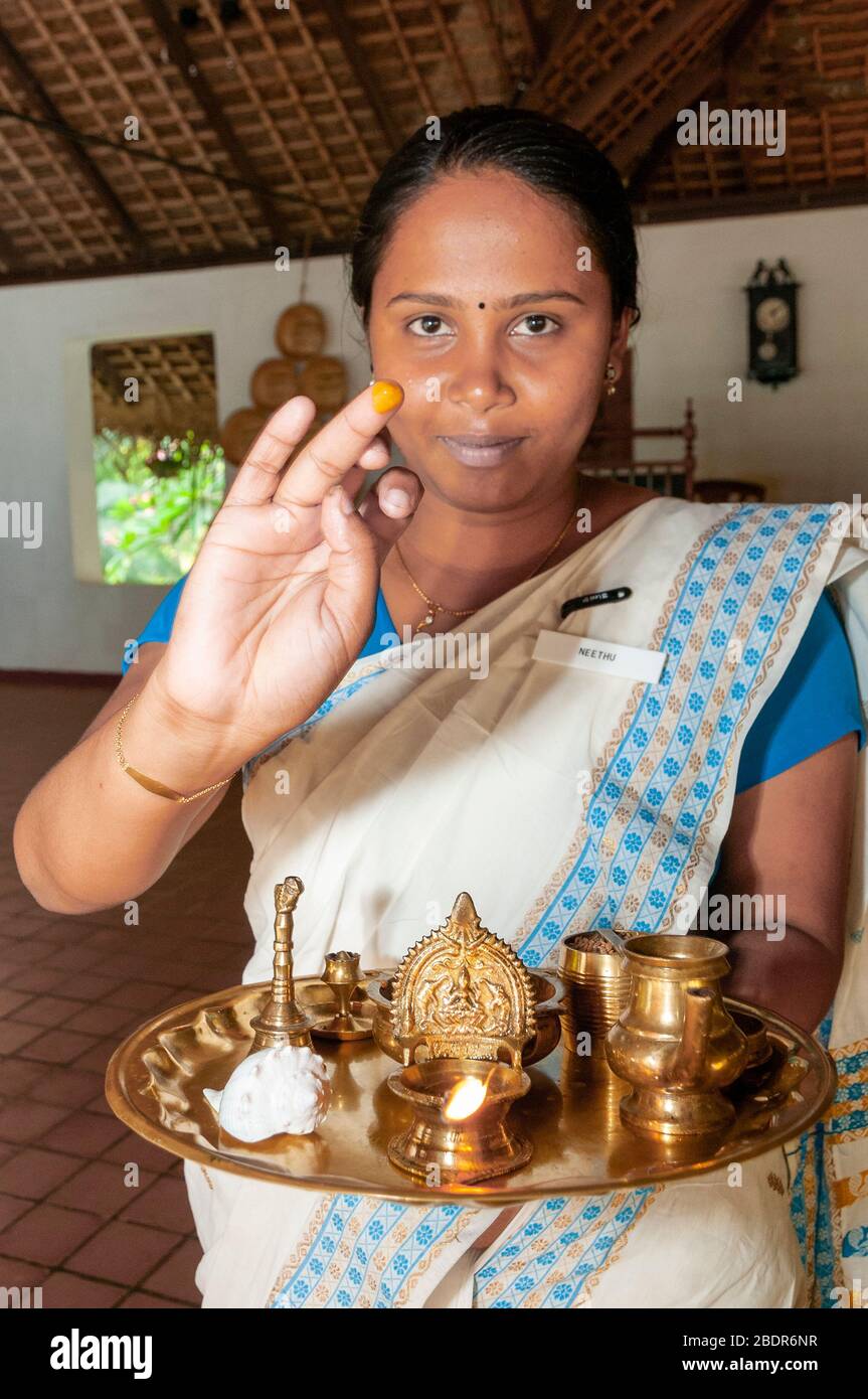 Indian girl in traditional dress greeting hotel guests at the Brunton ...