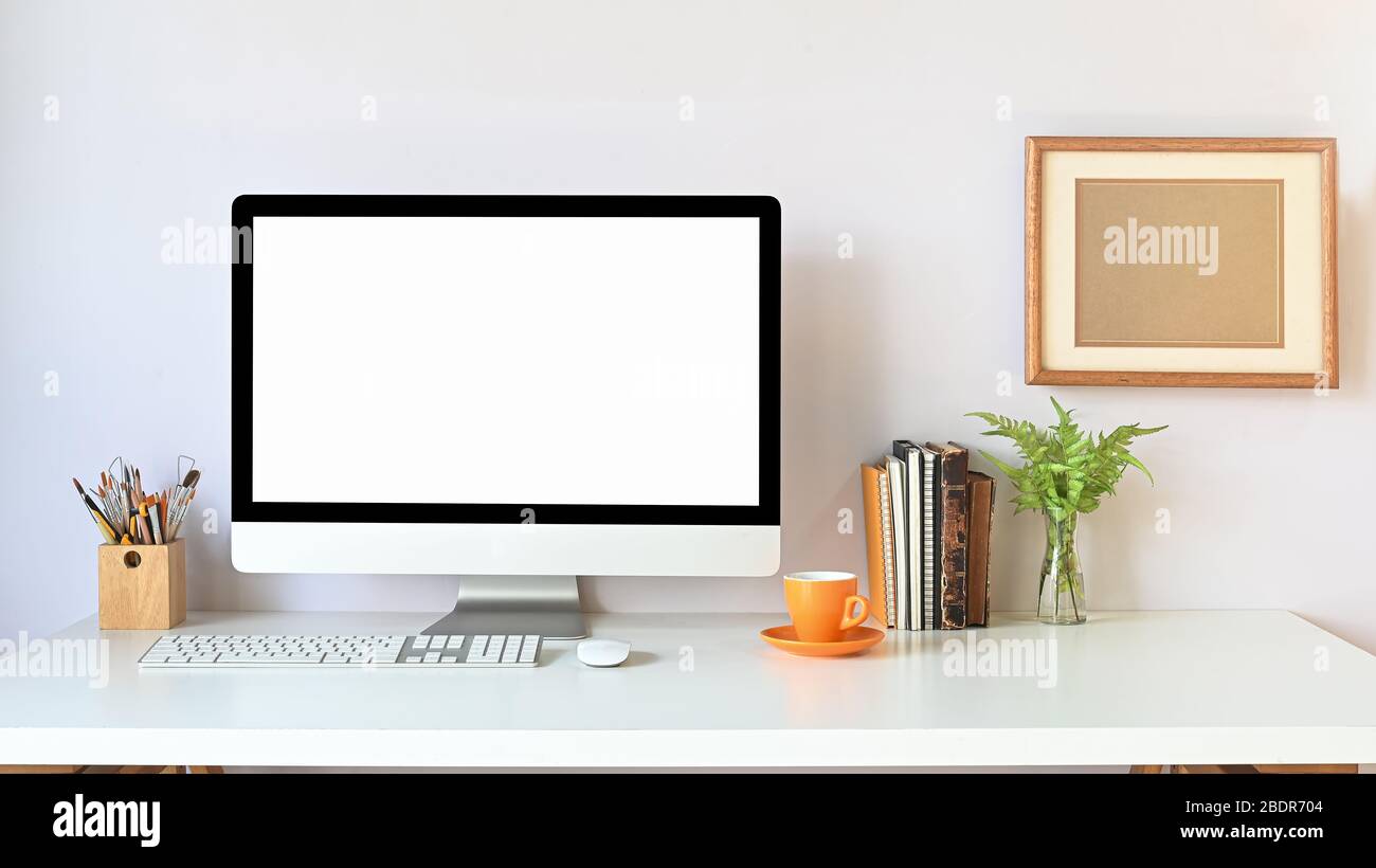 Workspace computer monitor putting on white working desk together with ...