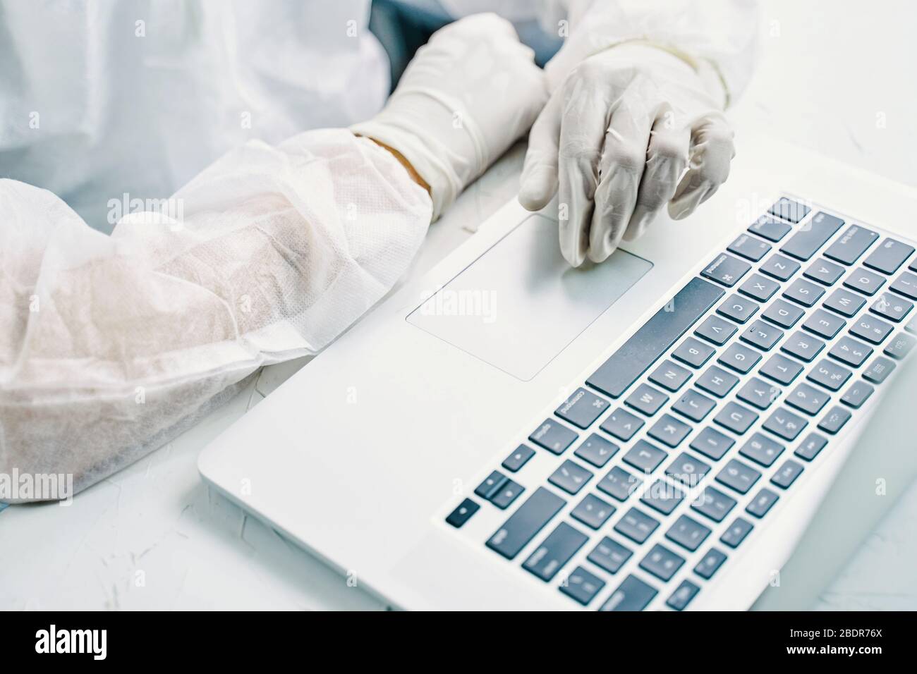 Bio hazard man with laptop. Man using a laptop on an table in ...