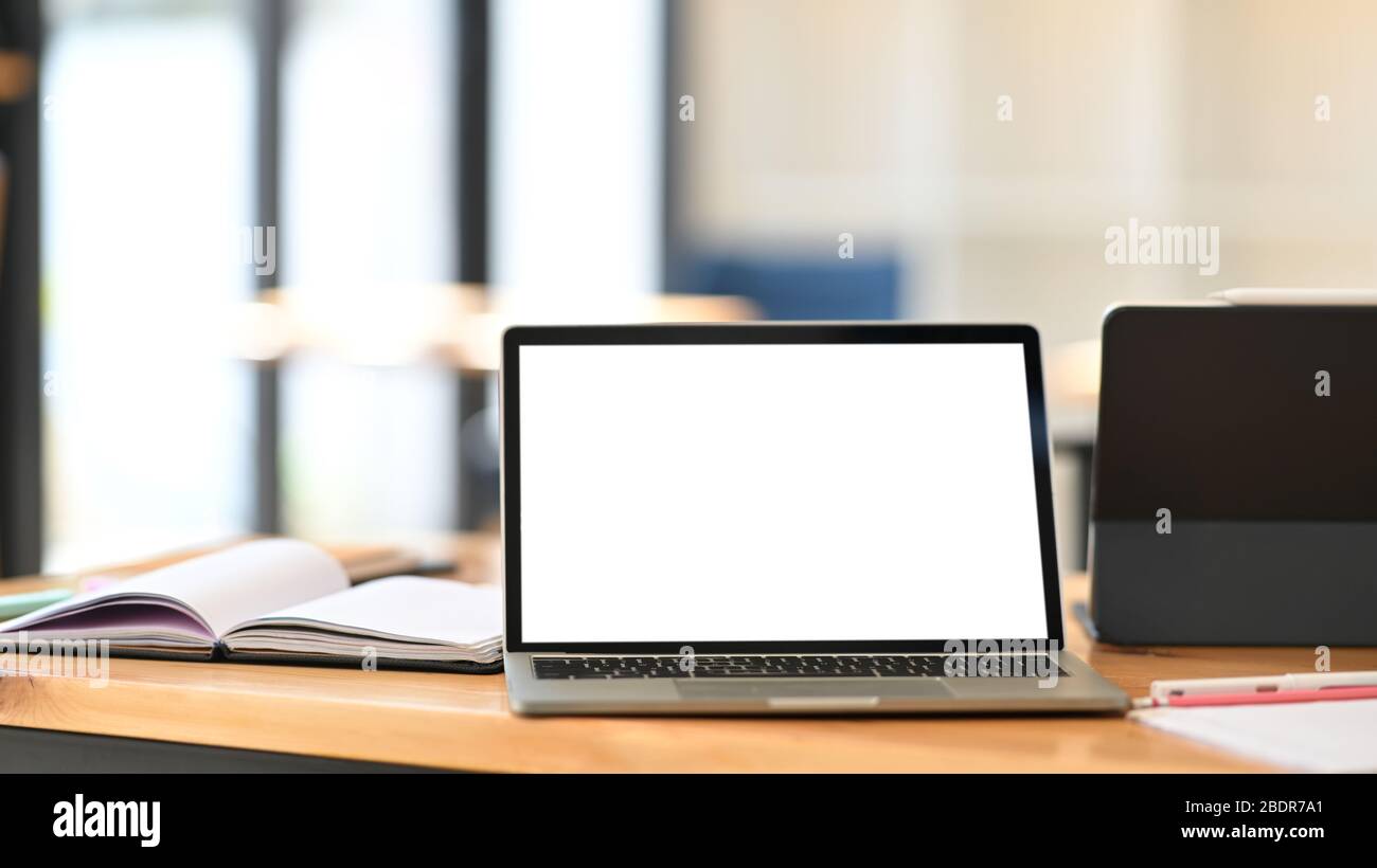 Photo of wooden working table full of equipment/office stuff. White ...