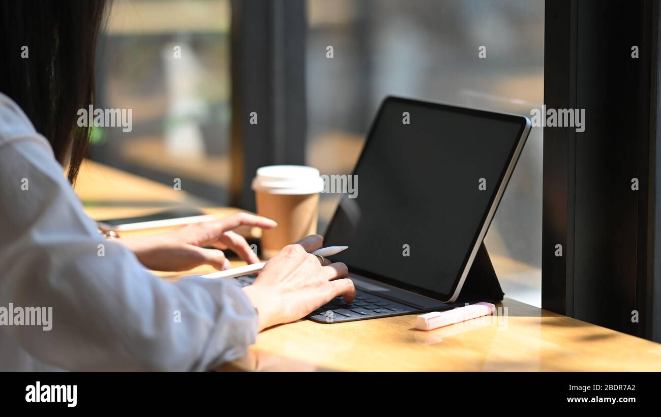 Cropped image of confident woman working with empty blank screen ...