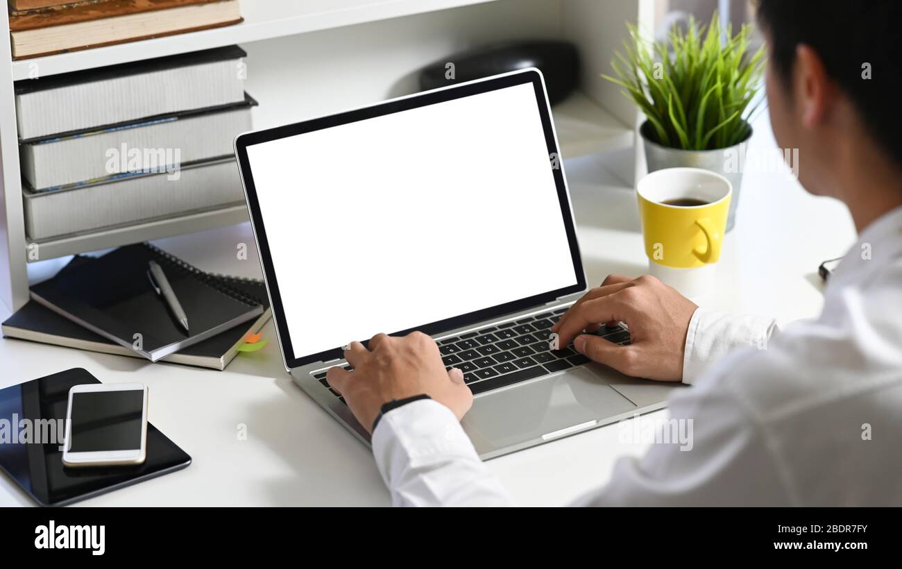 Behind of Young smart man working as Data analyst typing on computer ...
