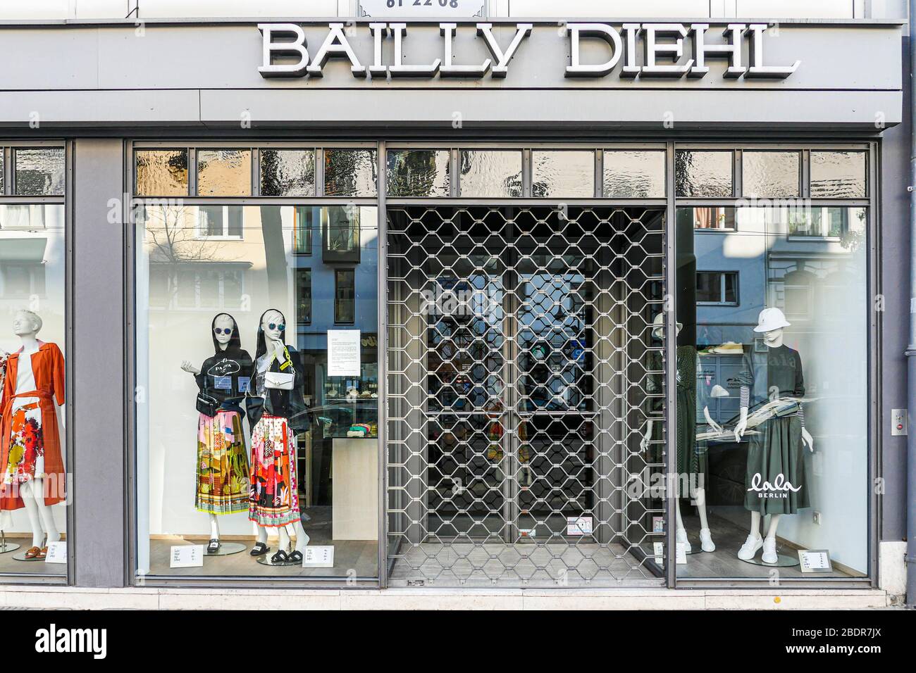 Barred Doors of Clothing Store During Covid-19 Pandemic Stock Photo - Alamy