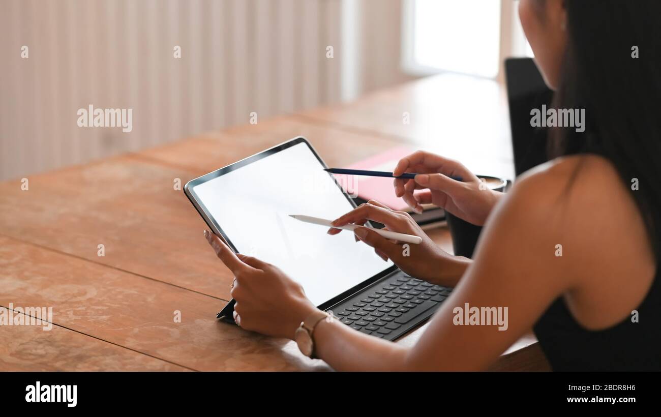 Side image of beautiful woman in striped shirt drawing on white blank ...
