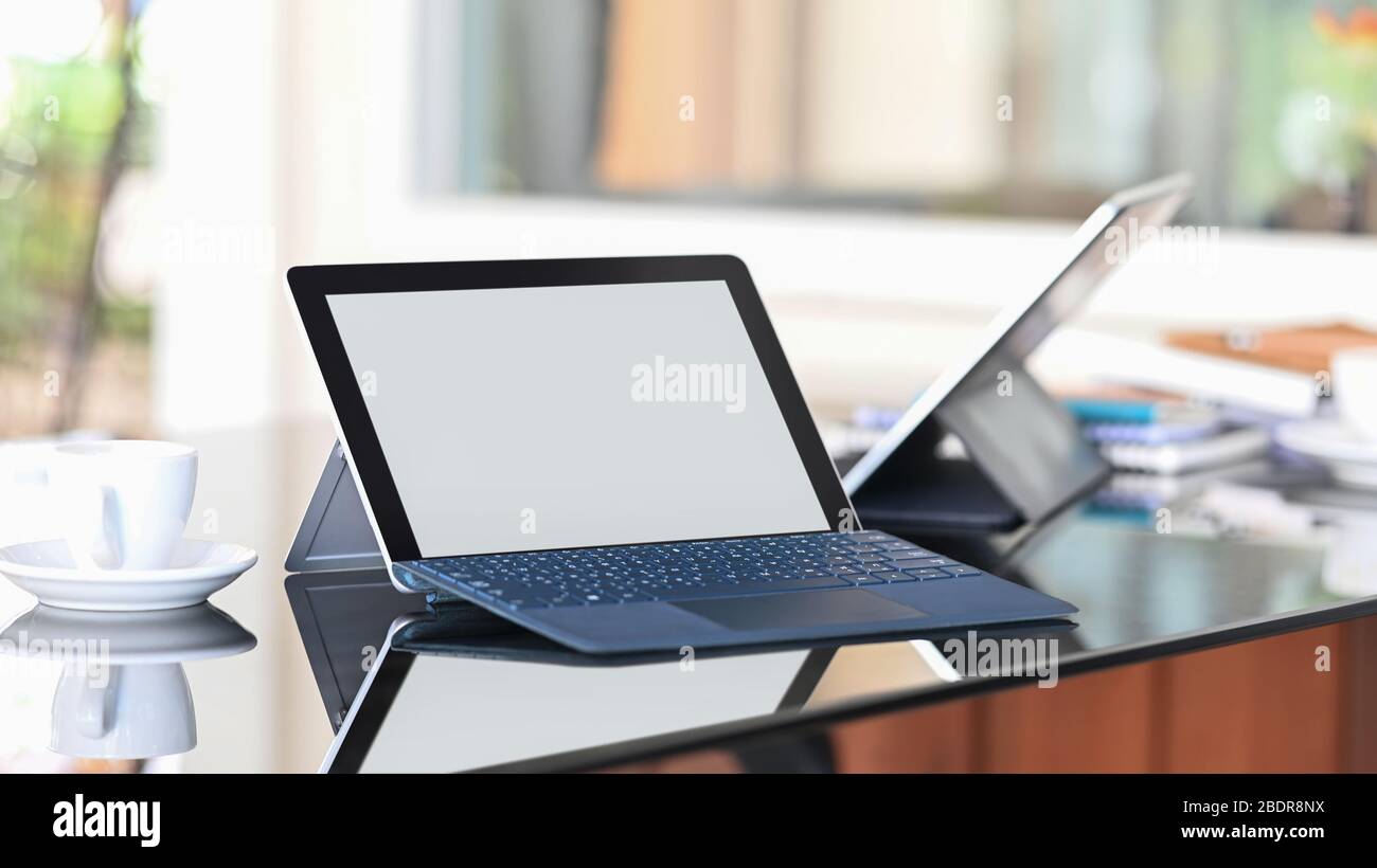 Photo of Glass working desk with office equipment putting on it with ...