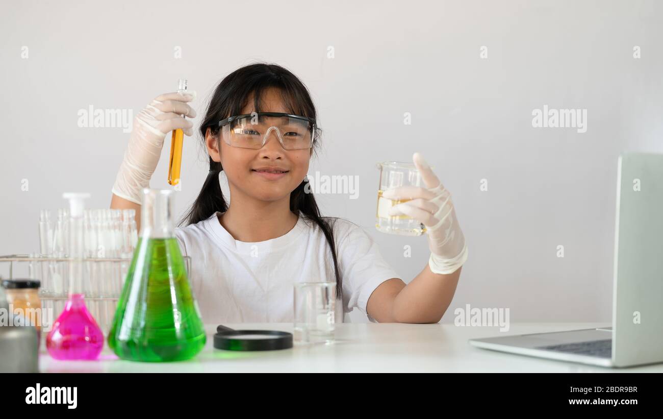 Photo of adorable schoolgirl doing a scientific experiment at the ...
