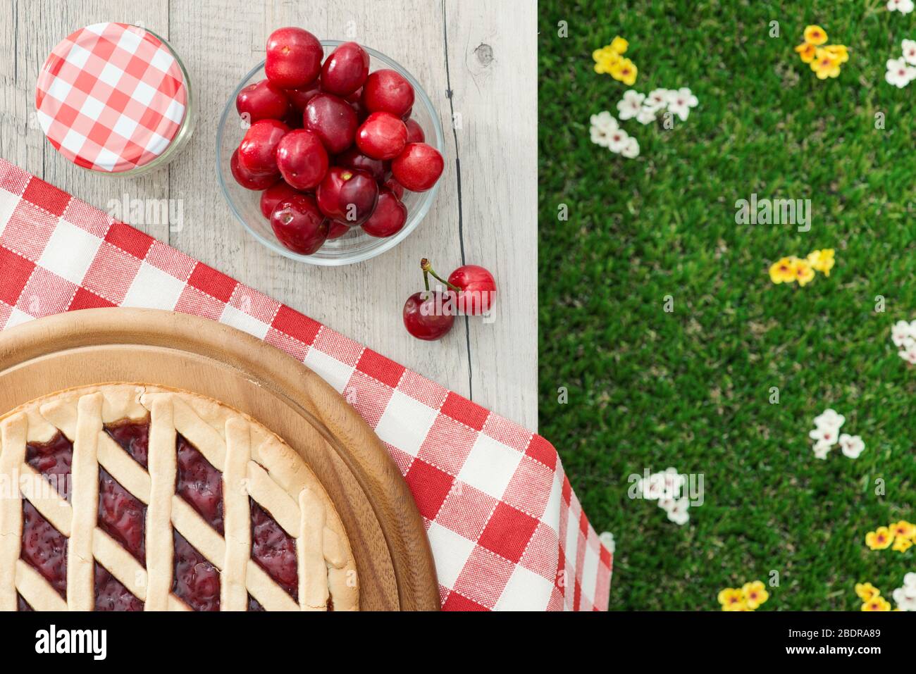 Picnic setting with tasty cherry pie and cherries, healthy eating ...