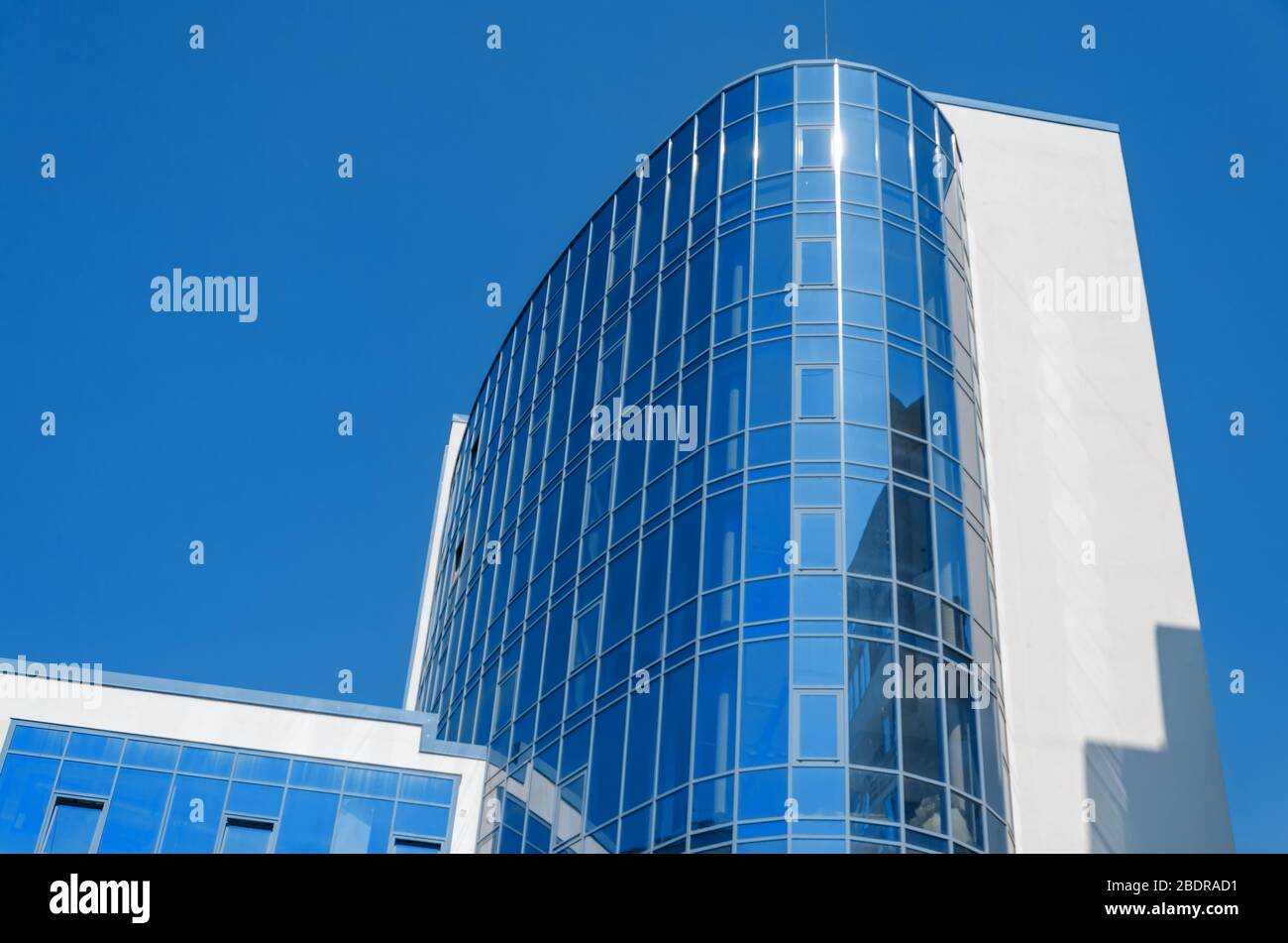 Modern office building in blue glass Stock Photo - Alamy