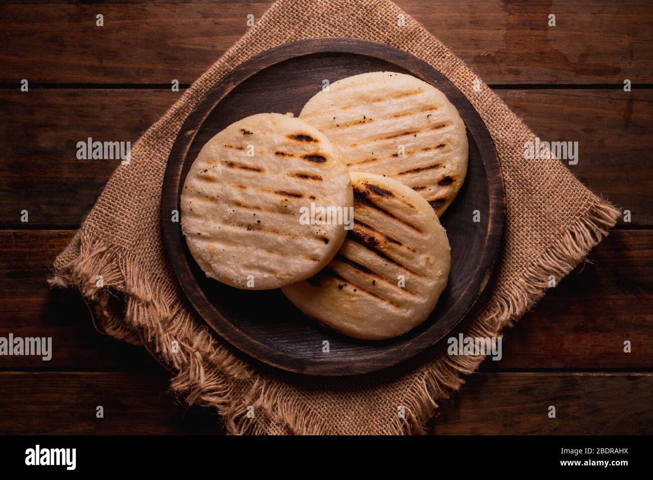 Top view of a group of traditional Latin American arepas on a wooden ...