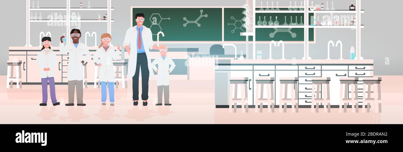 school students with teacher in uniform working in chemical laboratory ...