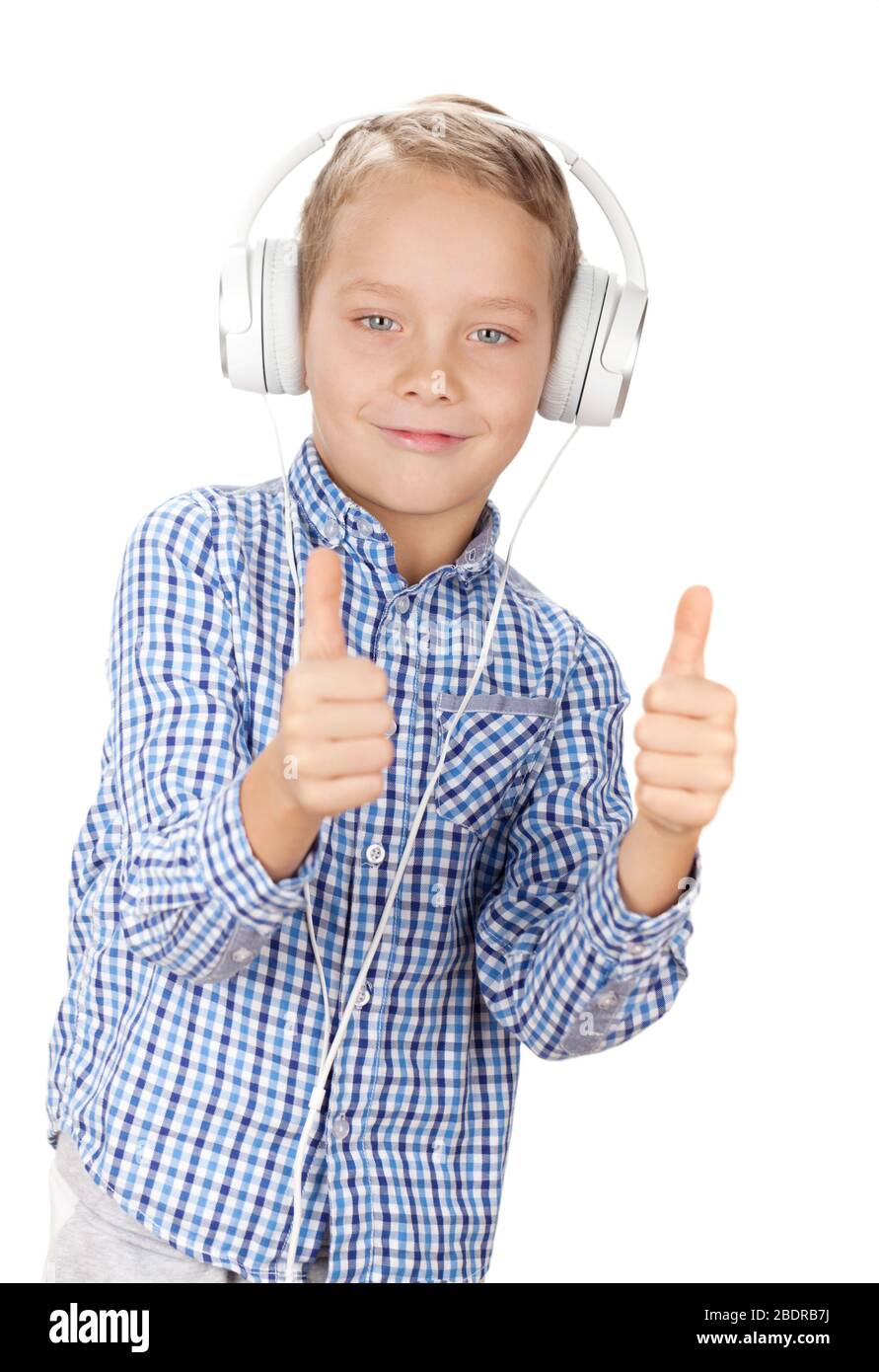 Young boy listening to music with headphones and making thumbs up ...
