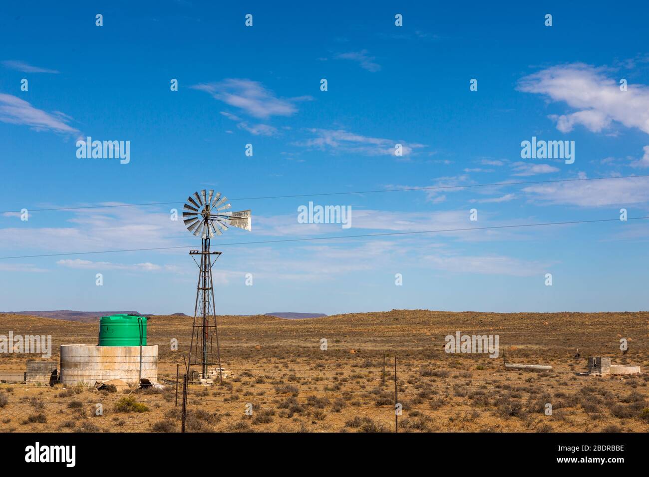 Windmill in wide open space Stock Photo - Alamy