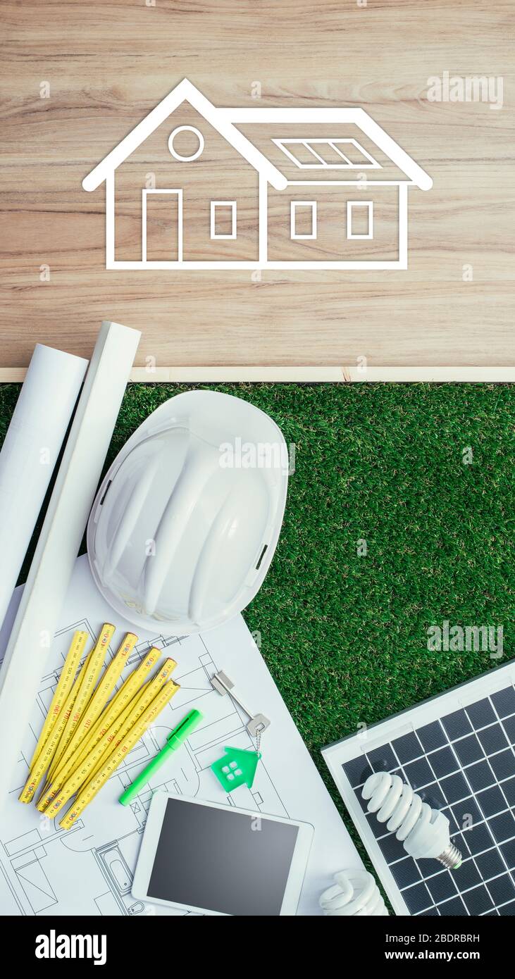 Green energy efficient house design, engineer desktop with projects ...