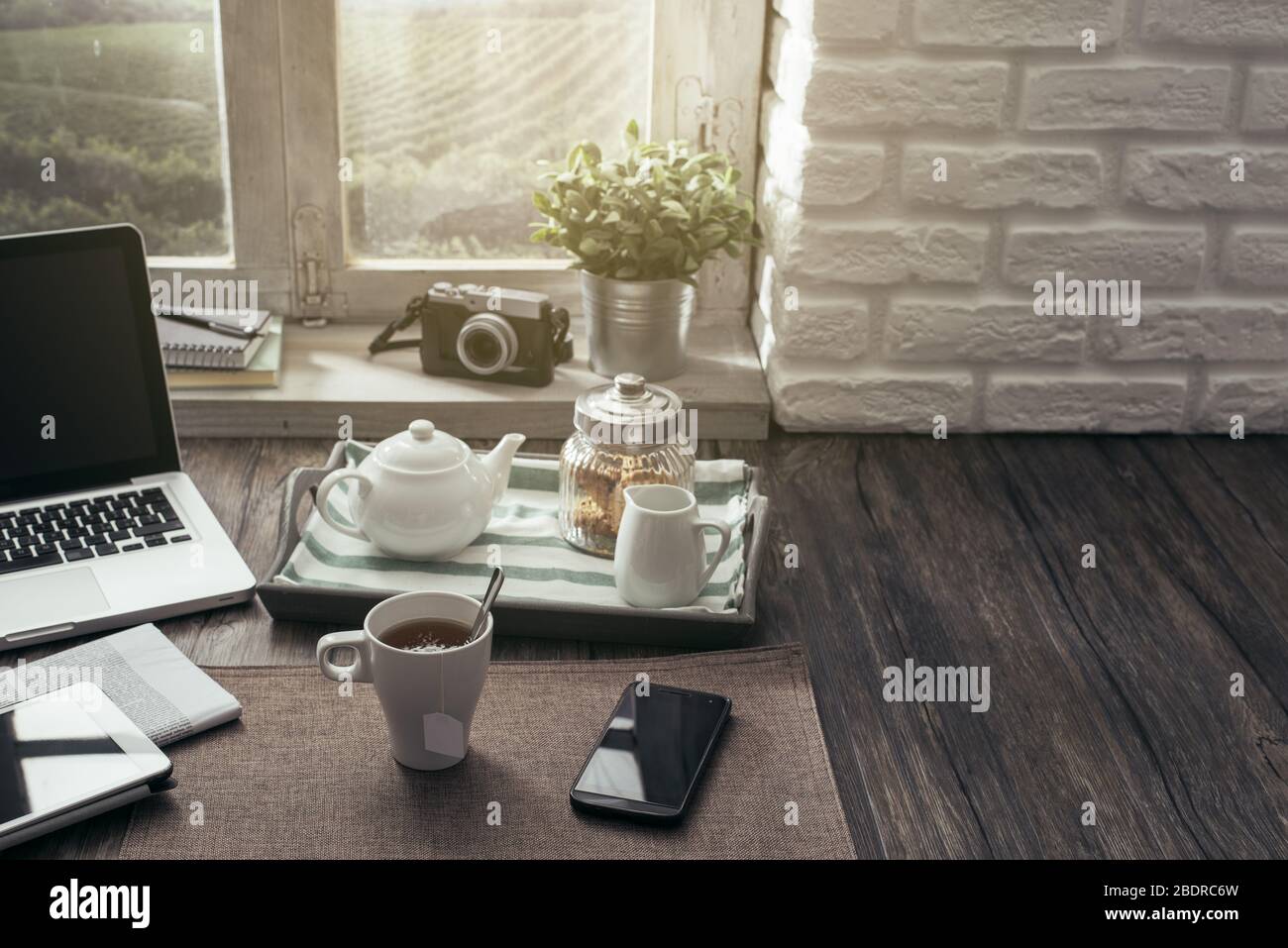 Healthy relaxing breakfast at home on a rustic wooden table with laptop ...