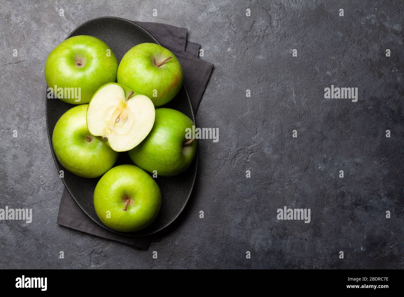 Ripe green apple fruits on dark stone table. Top view with copy space ...