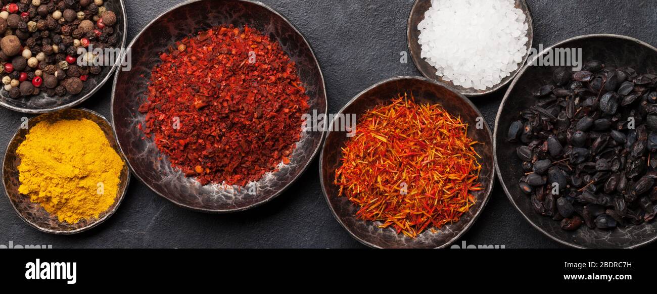 Various spices in bowl on dark stone table. Indian cuisine. Top view ...