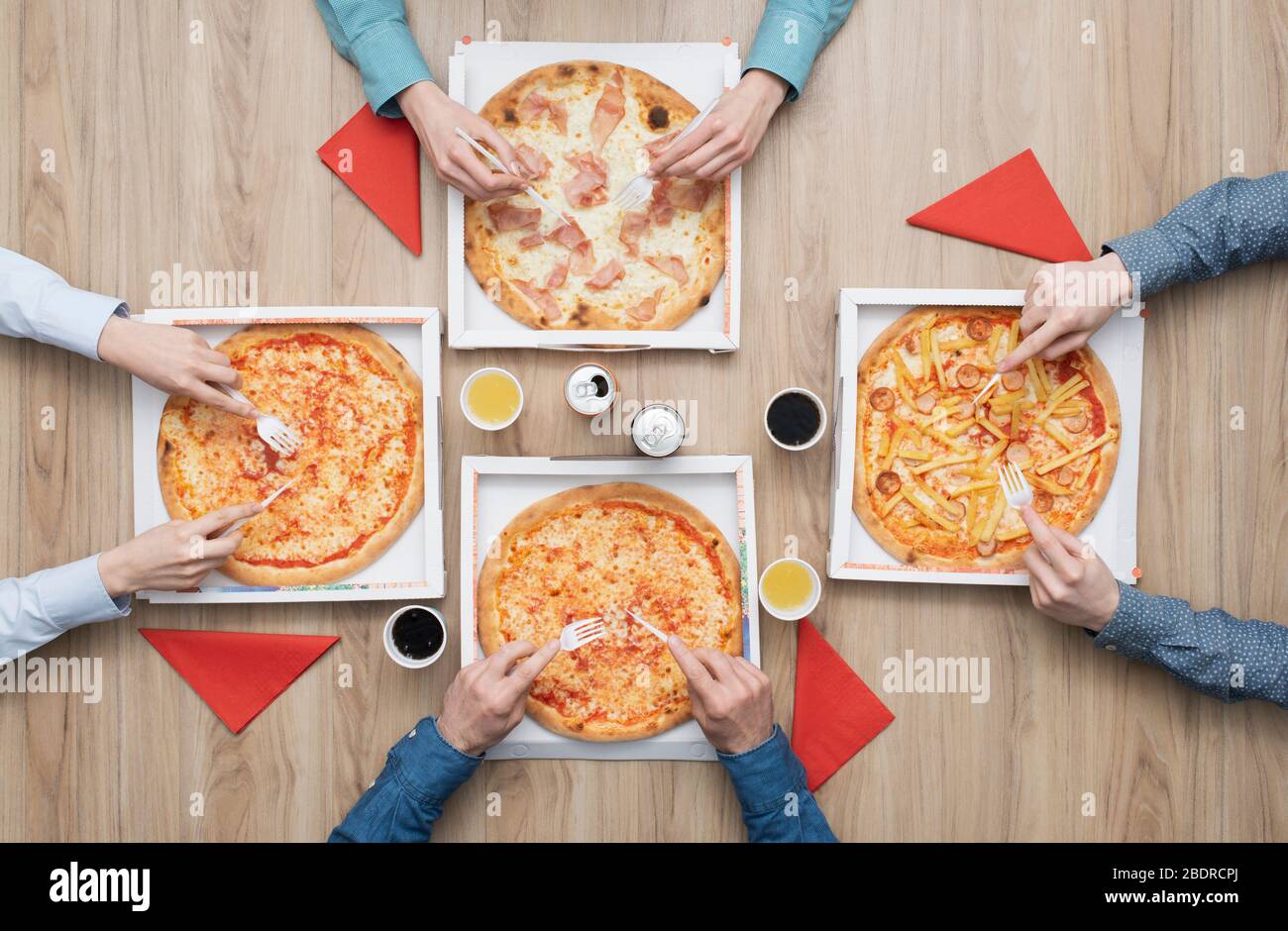 Group of friends having a pizza party at home and enjoying together ...
