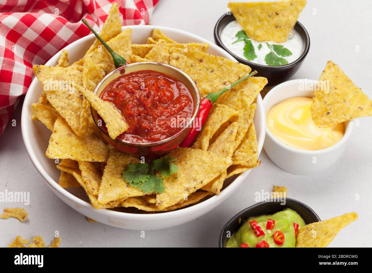Mexican nachos chips with various sauces - guacamole, salsa, cheese and ...