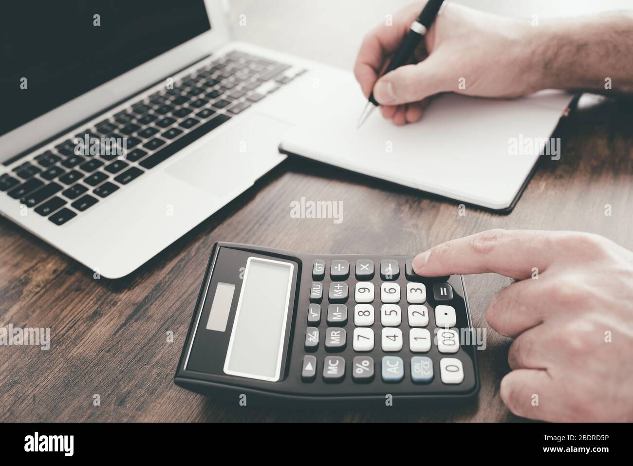 Calculating on office desk hi-res stock photography and images - Alamy