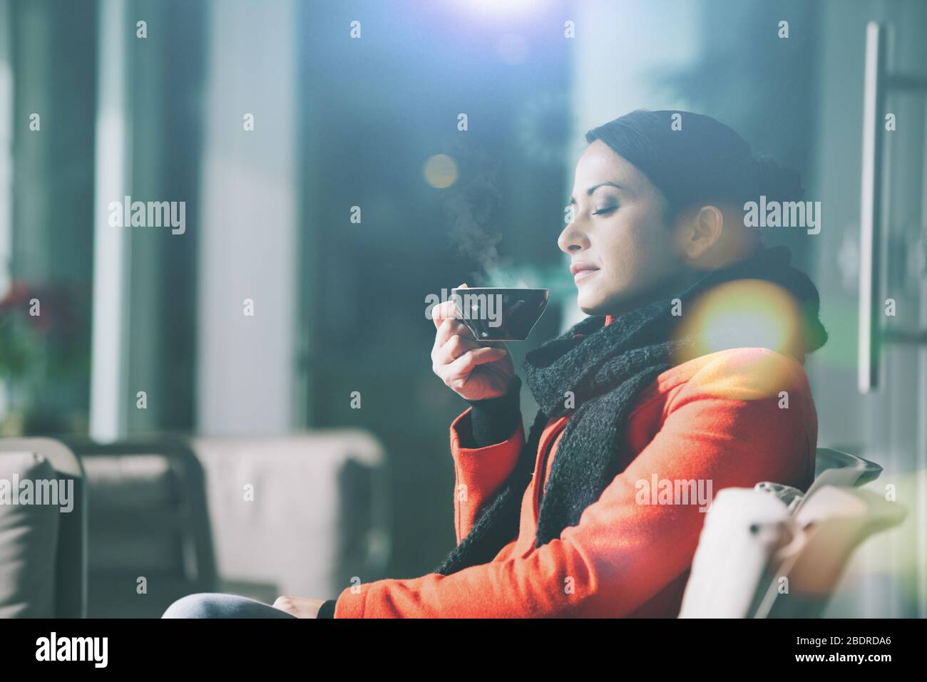 Attractive woman relaxing at the cafe and drinking an hot coffee Stock ...