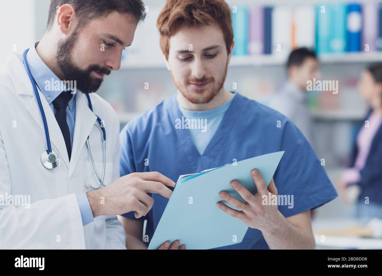 Medical team at the hospital checking paperwork and patient's medical ...