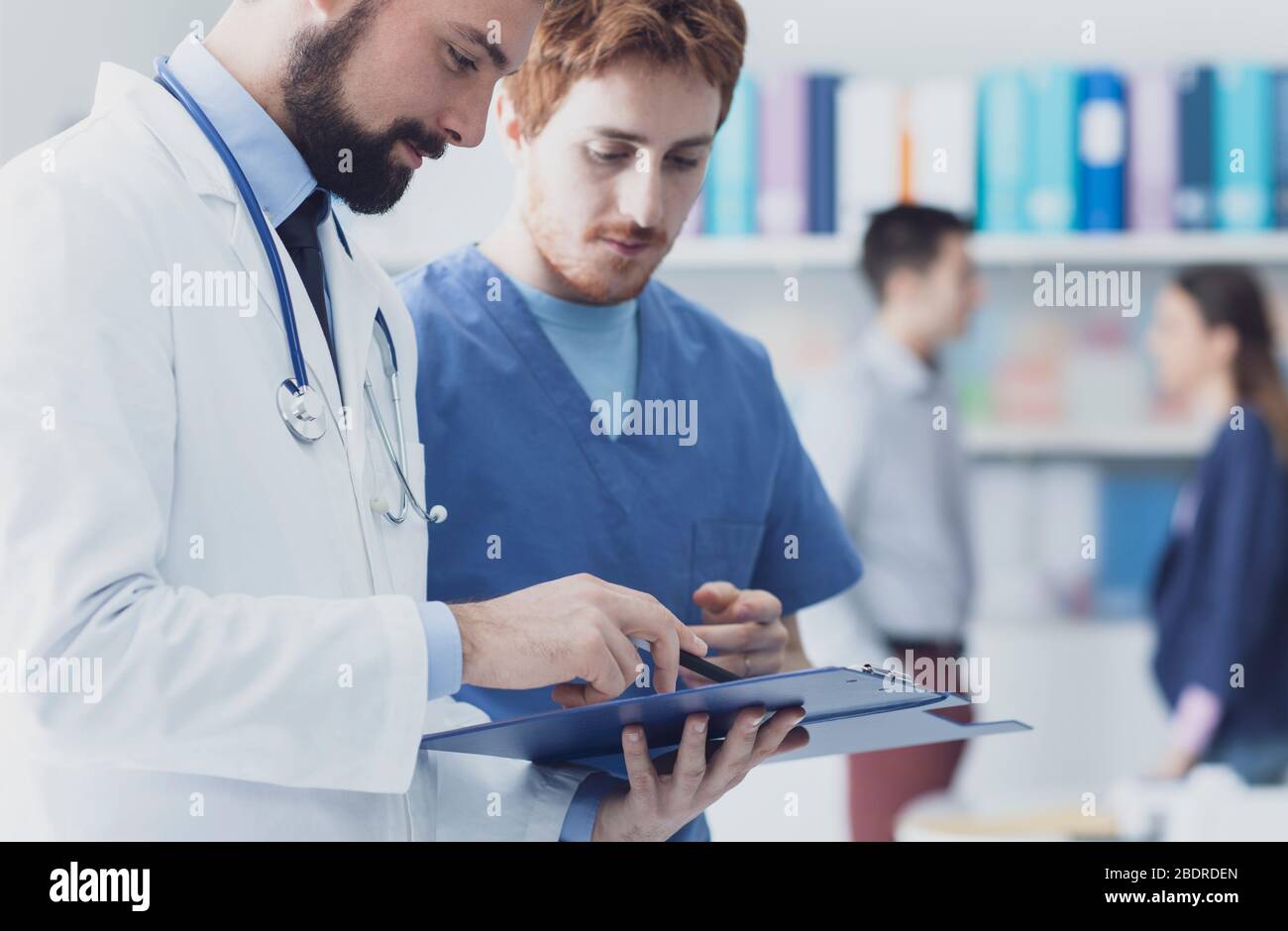 Medical team at the hospital checking paperwork and patient's medical ...