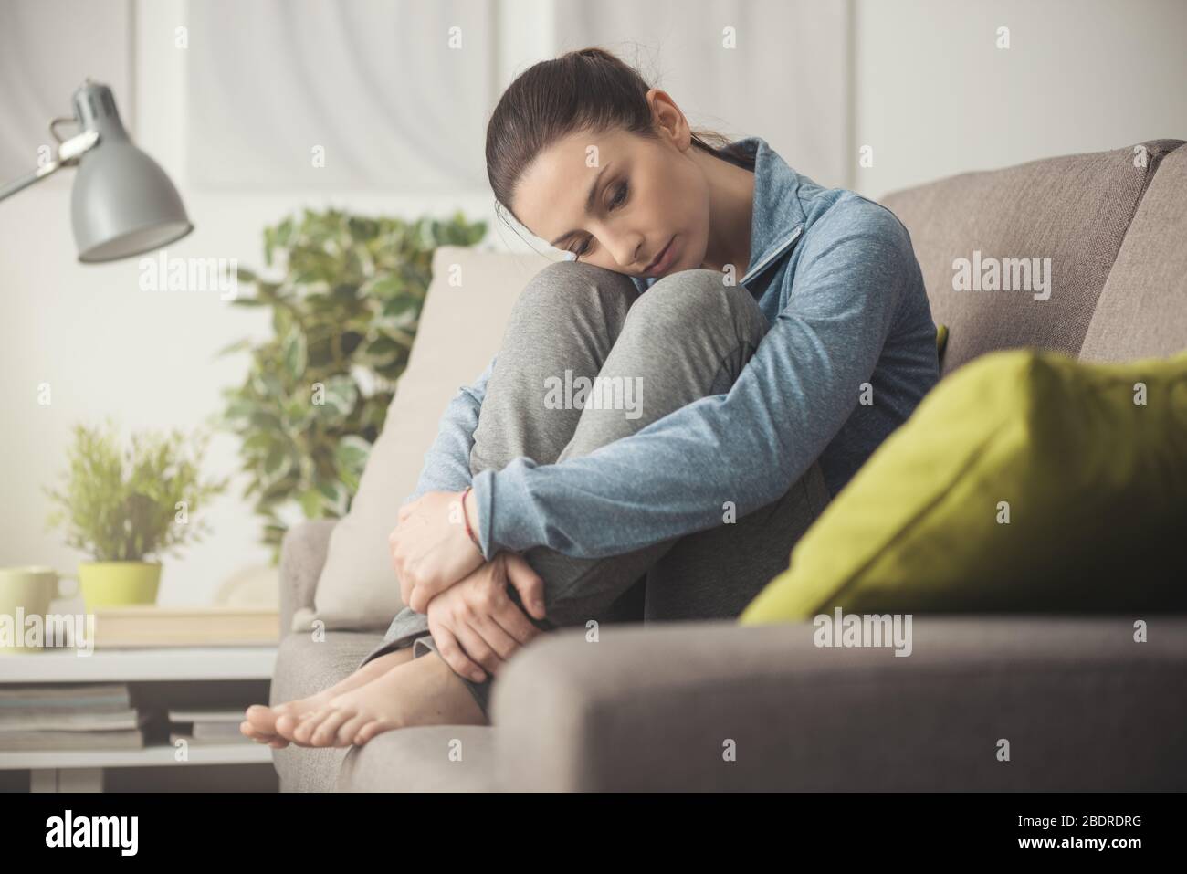 Sad suffering woman curling hi-res stock photography and images - Alamy