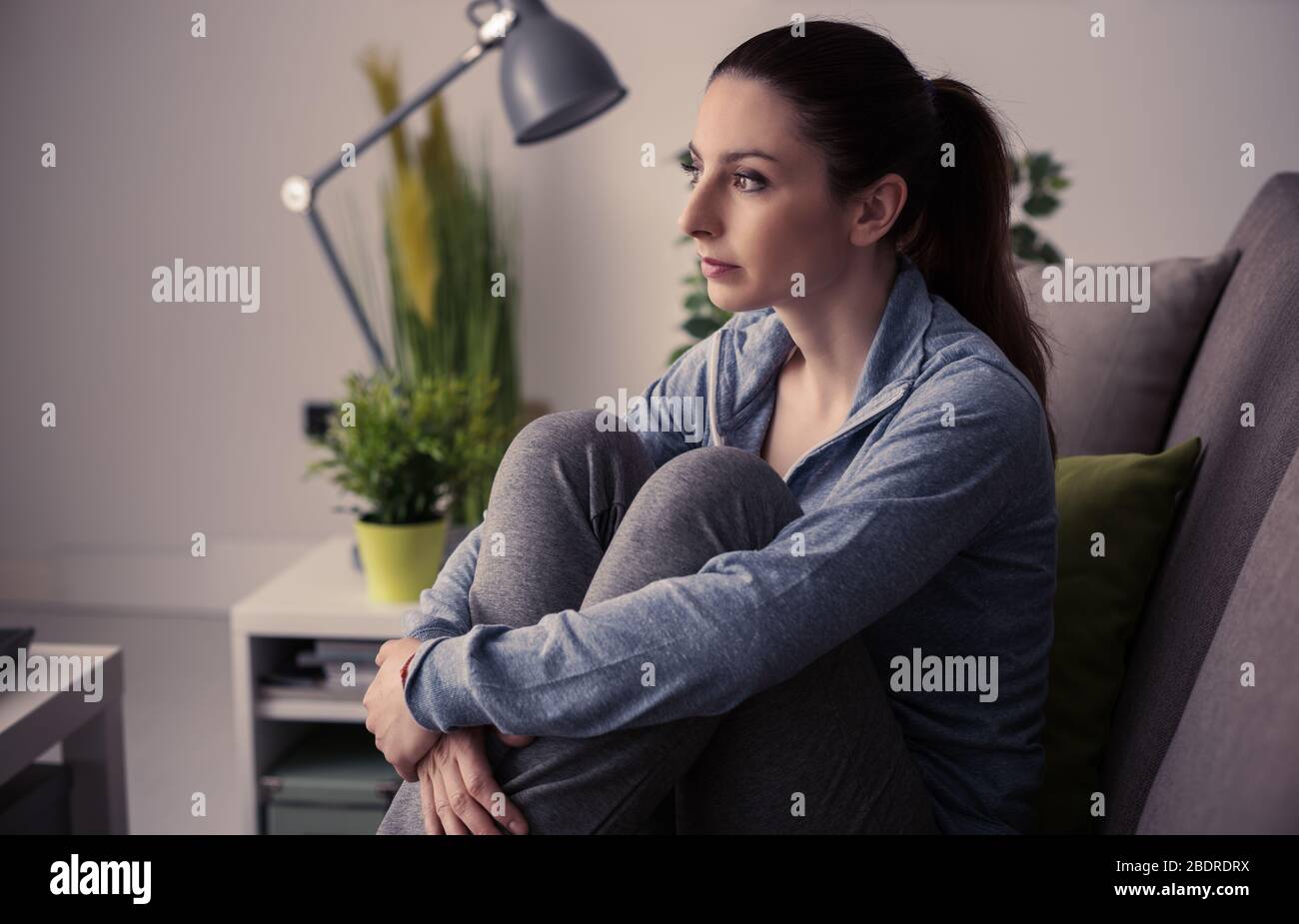 Sad suffering woman curling hi-res stock photography and images - Alamy