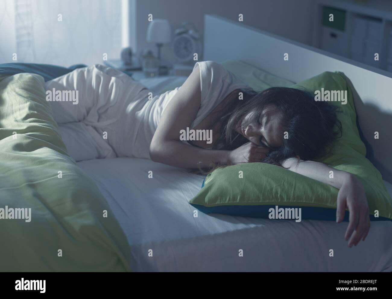 Young woman sleeping in her bed at night and lying on her arm Stock ...