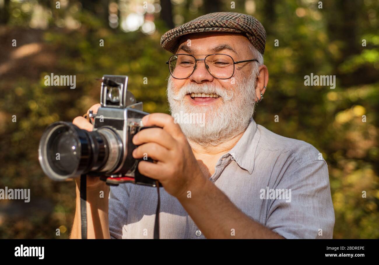 Landscape nature photo. Old photographer filming. Make perfect frame ...