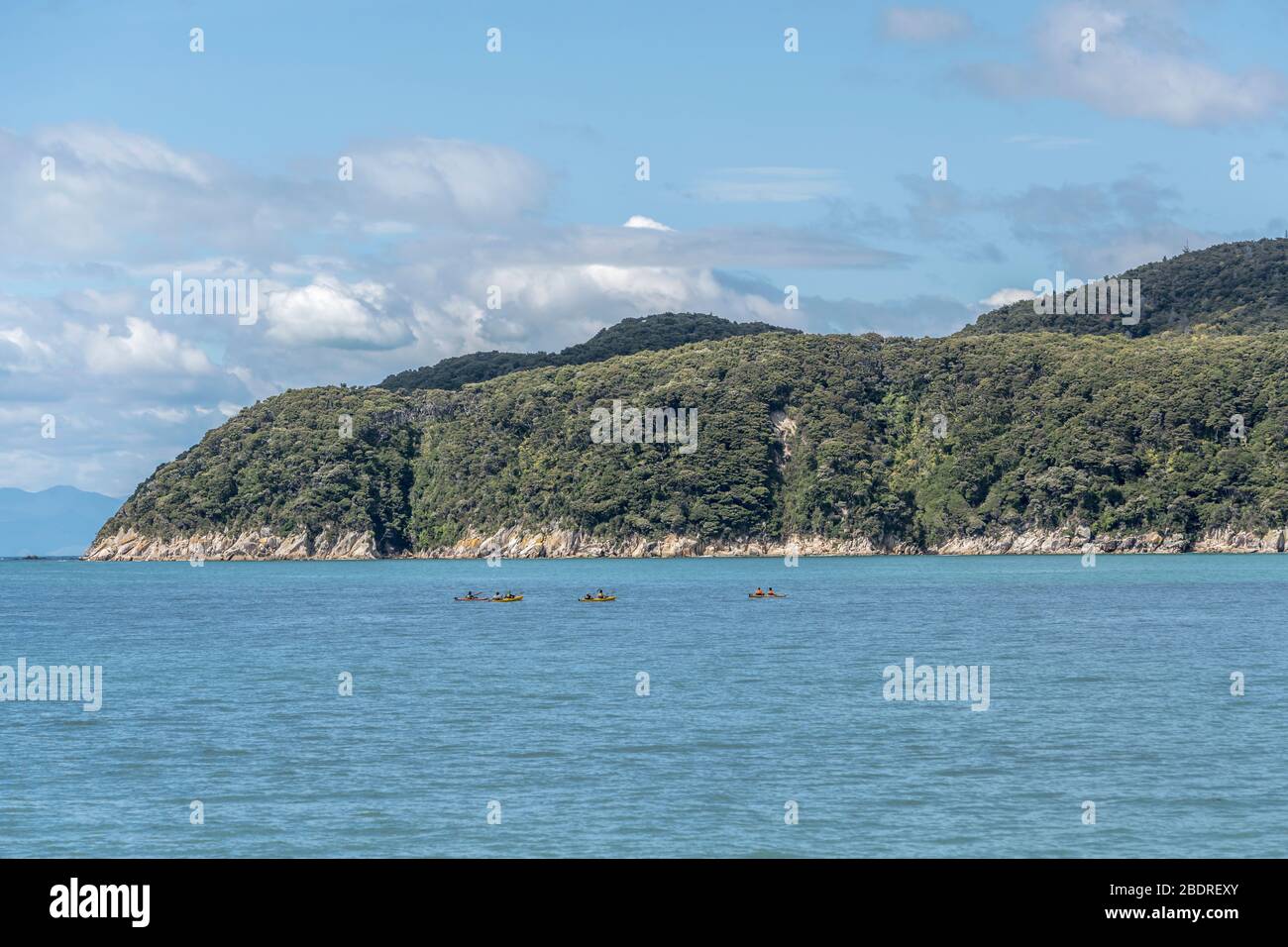 landscape with kayak flotilla sailing in Tonga bay, shot in bright ...